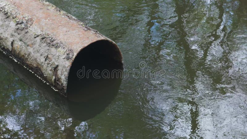 Old Rusty Sewer Pipe for Discharging Waste into Pond Stock Footage ...