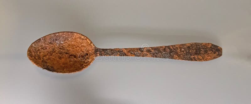 A Rusty Spoon on the Sand among the Stones Stock Photo - Image of rusty ...