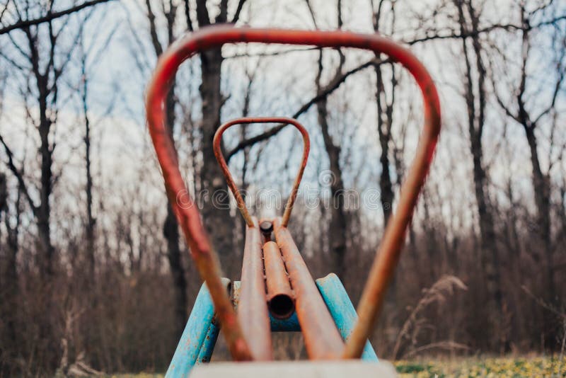 An Old Rusty Swing Next To the Woods. Bottom View Stock Photo - Image ...