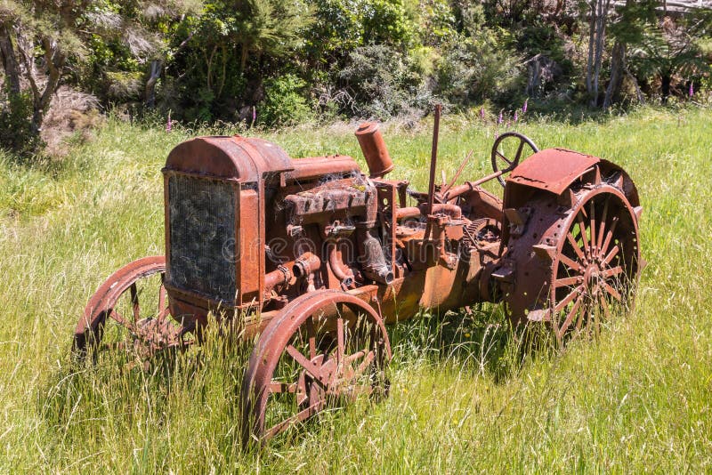 Old Rusty Tractor in Grass Field Stock Photo - Image of agriculture ...
