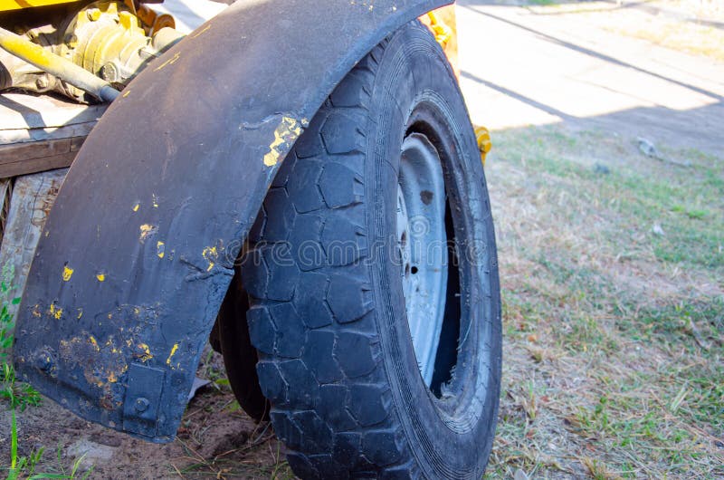 Old Rusty Tractor`s Flat Back Tire. Industrial Stock Image - Image of ...