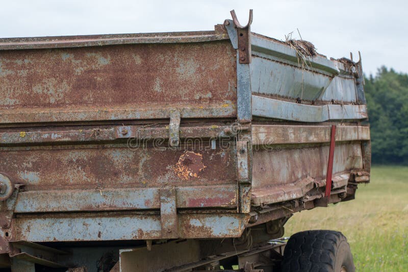 Old Rusty Tractor Trailer in the Green Field Stock Image - Image of ...