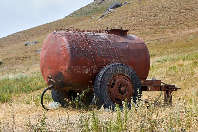 Old Rusty Water Tank on Wheels on a Hillside Stock Image - Image of ...