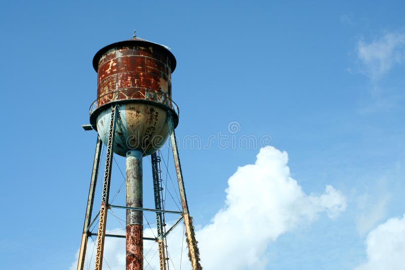 Old Rusty Watertower Against Blue Sky Stock Image - Image of blue ...