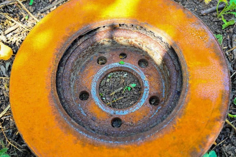 An Old, Rusty, Wet Wheel Covered with Fresh Raindrops Outdoors. Rust on ...