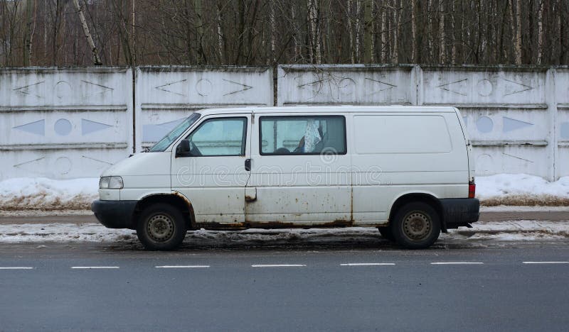 Old Rusty White Minivan Parked at a Gray Concrete Fence Stock Image ...