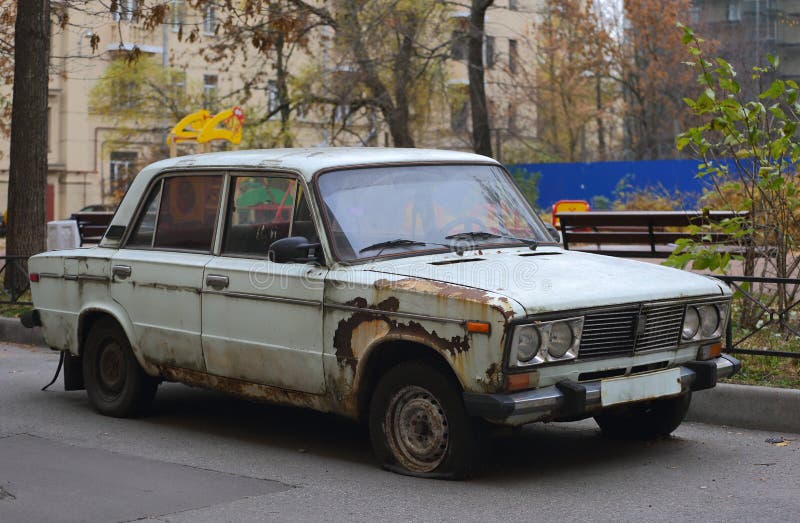 An Old Rusty White Soviet Passenger Car in the Courtyard of a ...