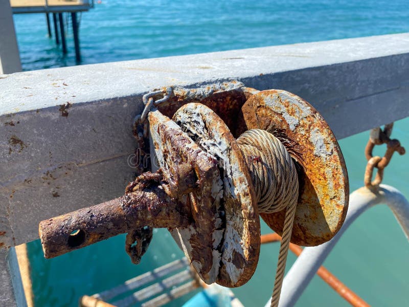 An Old Rusty Winch with an Iron Rope Rope on a Reel Stock Photo - Image ...