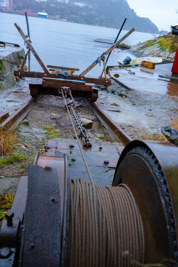Old Rusty Winch with Metal Cable Pulling a Slip by the Sea.. Stock ...