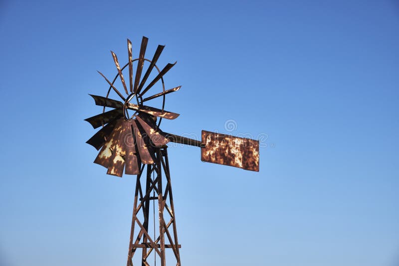 Old Rusty Wind Mill or Wind Pump Opposite Clear Blue Sky Stock Image ...