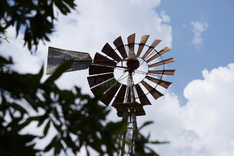 Old Rusty Windmill and Branches in a Foreground Stock Image - Image of ...