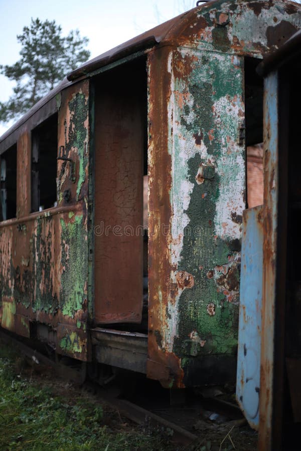 An Old Rusty Windowless Wagon with Peeling Green Paint Stands on the ...
