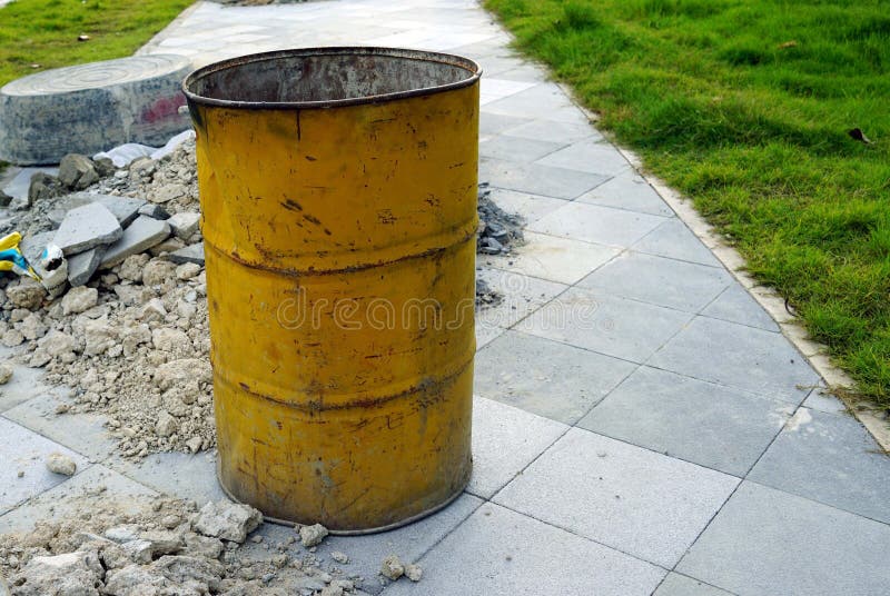 Old Rusty Yellow Barrel on the Ground in the Construction Site Stock ...
