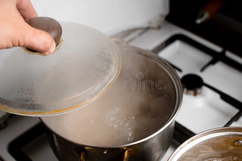 An Old Saucepan with Boiling Water and an Open Lid Stock Photo - Image ...