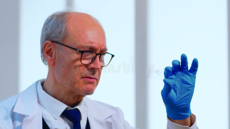 Old Scientist Man Analysing Virus Sample in Modern Laboratory Stock ...