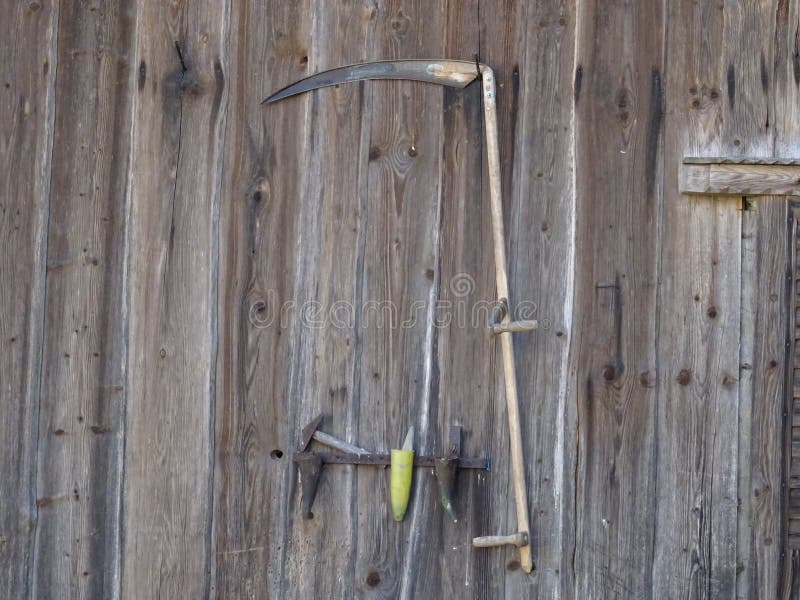 Old scythe on a wood wall stock image. Image of wood - 214824441