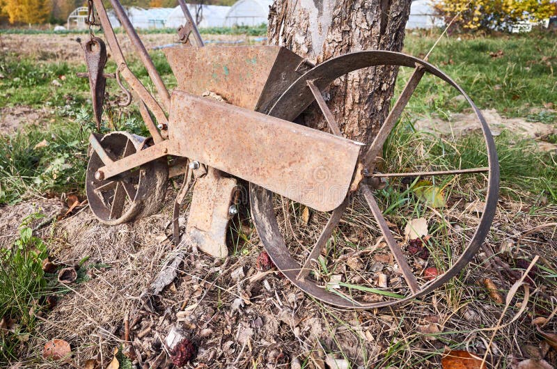 Old Seeding Machine Leaning Against a Tree Stock Image - Image of ...