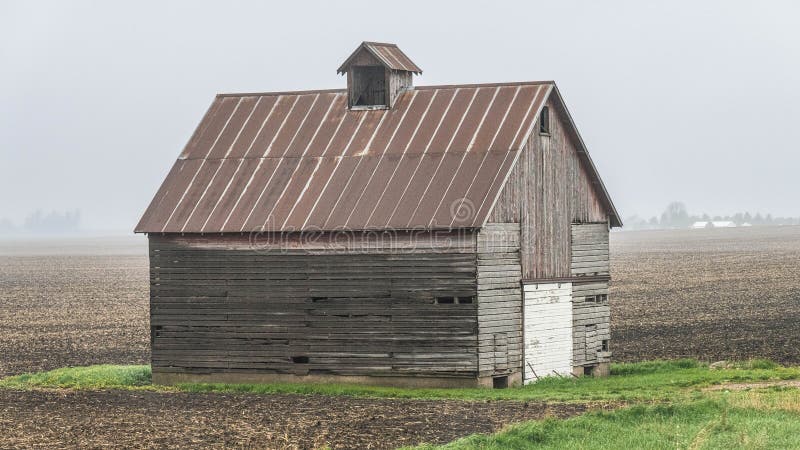 An Old Shed Sits Alone in a Field of Brown Grass Stock Image - Image of ...