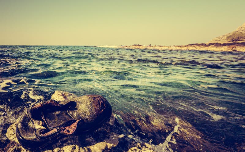 Old shoe beside sea stock photo. Image of glow, perspective - 69582458