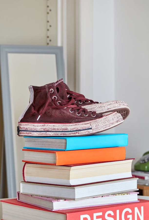 Old shoes on books stack stock photo. Image of attitude - 208598430