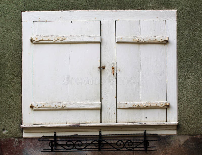 Old Shutter Window with Closed White Doors and an Empty Metal Planter ...