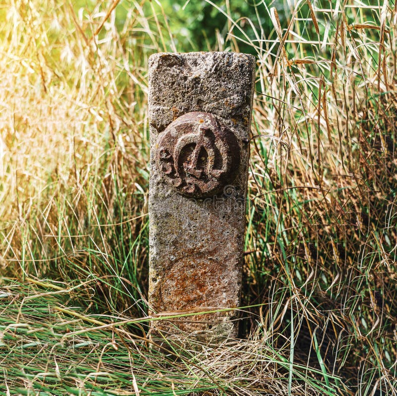 Old Sign on Short Concrete Pole with Hammer and Sickle among Dry Grass ...