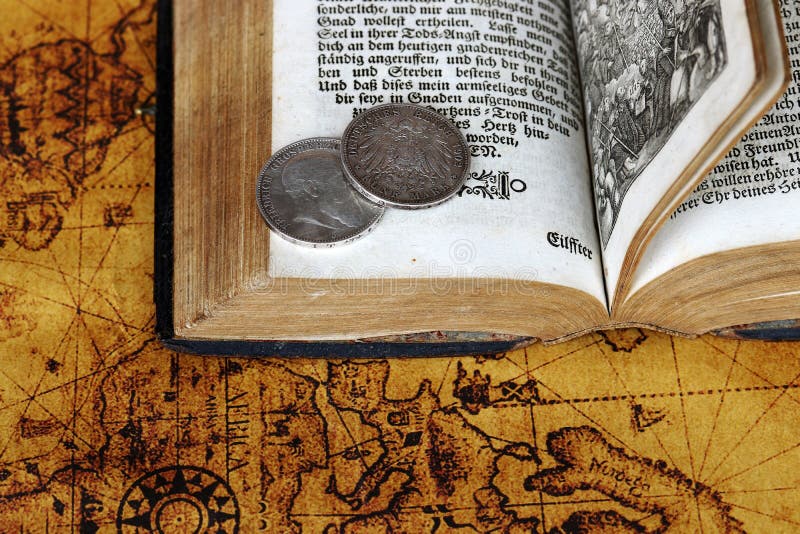 Old Silver Coins from 1902 and an Antique Book from 1763 on a World Map ...