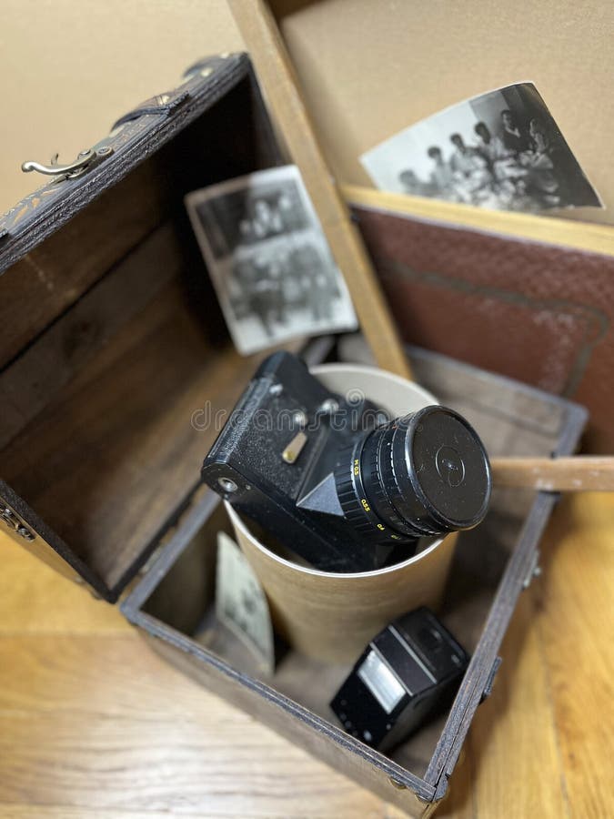 An Old SLR Camera in a Frame and in a Chest Stock Photo - Image of ...