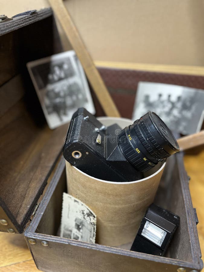 An Old SLR Camera in a Frame and in a Chest Stock Photo - Image of ...