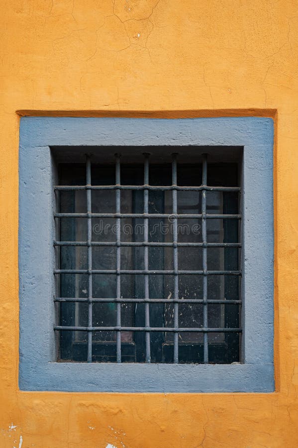 An Old Small Window with a Square Lattice, Like a Prison on the Yellow ...