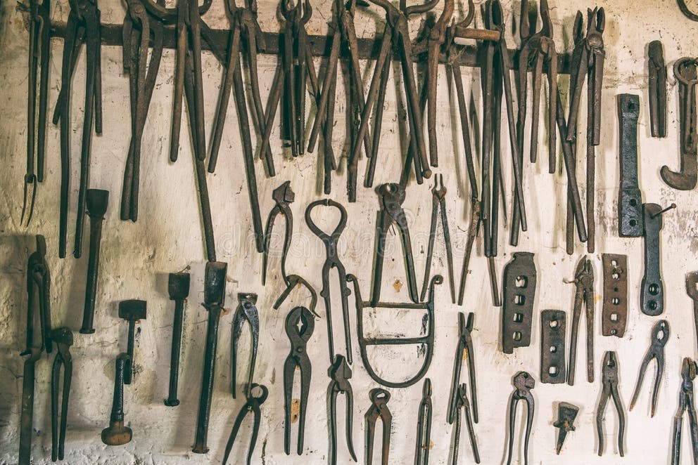Smithy tools on the wall stock photo. Image of horseshoe - 132687132