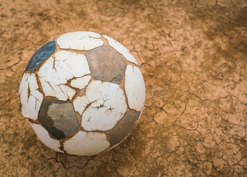 Old Soccer Ball on Dry and Cracked Ground Texture . Stock Photo - Image ...