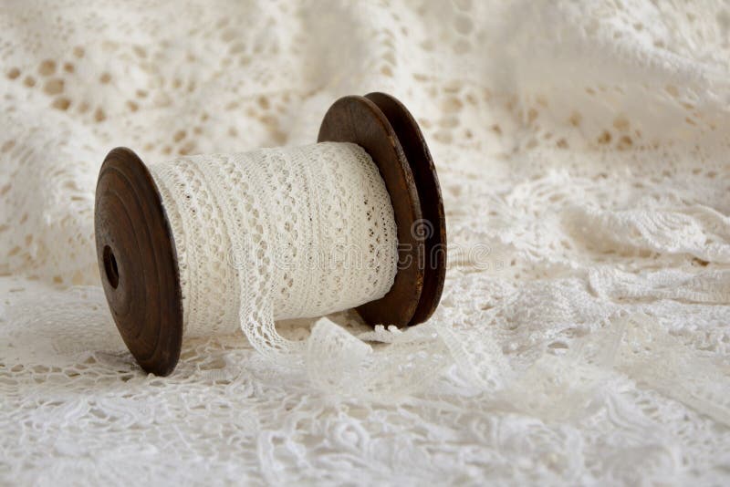 Old Spool with White Lace on the Table with Vintage Lace. Stock Photo ...