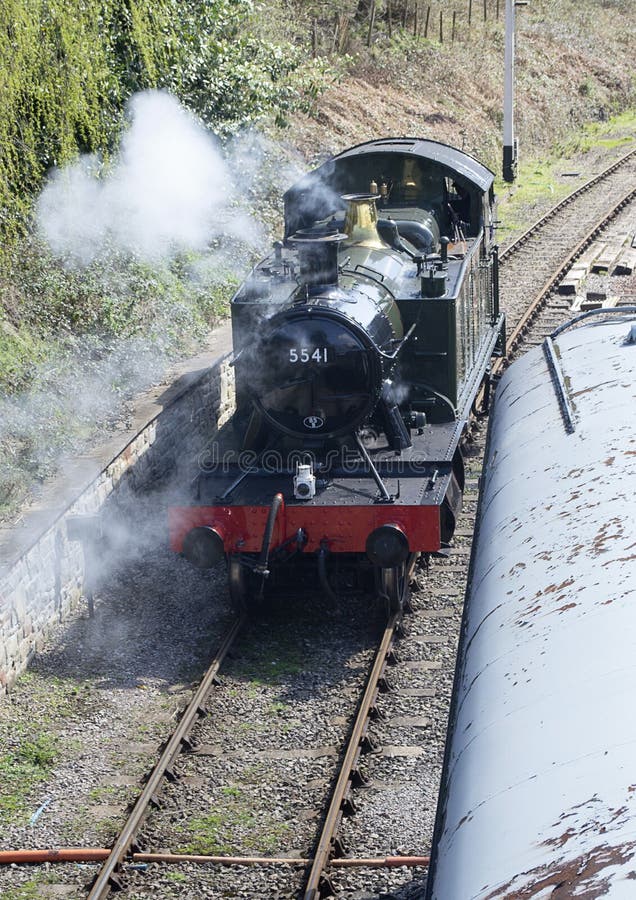 Old Steam Engine on Tracks Showing Puffs of Steam Stock Photo - Image ...