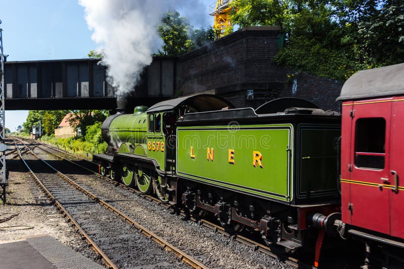 Old Steam Train Pulling Away from Station. Editorial Photography ...