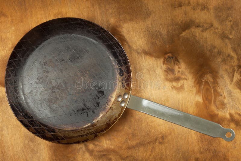 Old Steel Frying Pan on a Wooden Background. Kitchen Tools. Stock Image ...