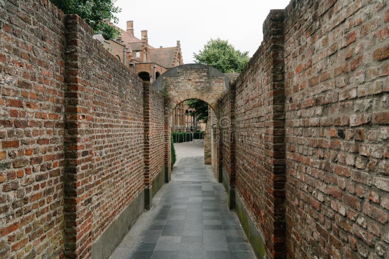 An Old Stone Alley in Brugge, Belgium Stock Image - Image of arch ...
