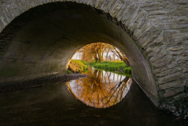 Old Stone Arch Bridge Above a Tranquil River. Stock Image - Image of ...