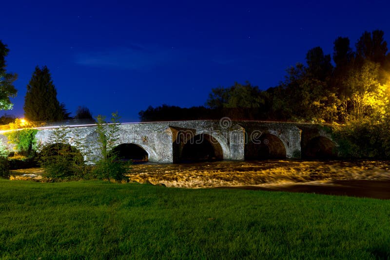 Old Stone Bridge Over Fast Flowing River, with Car Trail. Stock Photo ...