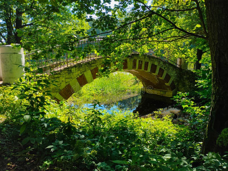 Old Stone Bridge in Park, Vibrant Green Color Stock Image - Image of ...