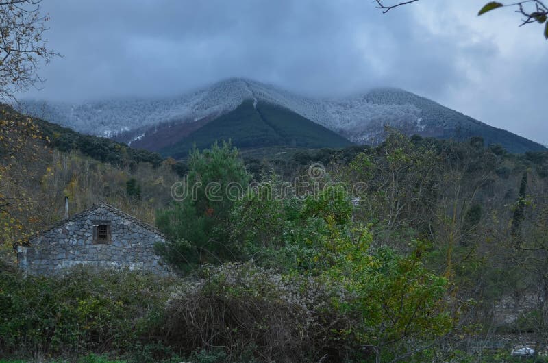 Old Stone Cabin with Mountain Falling Snow on it. Stock Image - Image ...