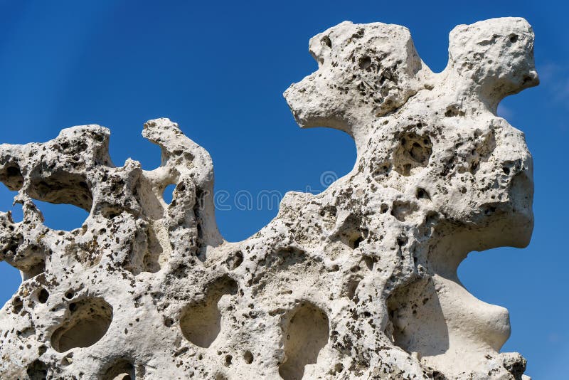 An Old Stone of Complex Shape Against the Background of a Blue Sky ...