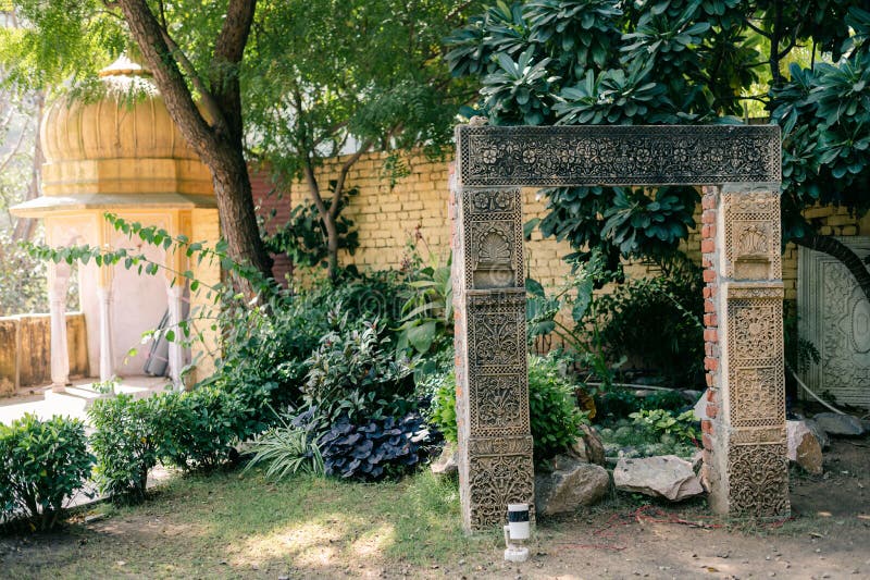 Old stone gate in garden stock photo. Image of plant - 261111114