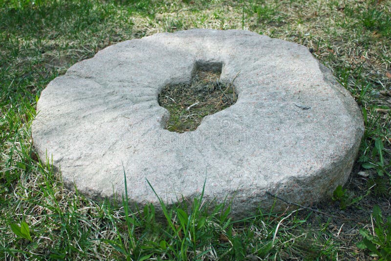 Old Stone Millstone in the Grass Stock Image - Image of rock, natural ...