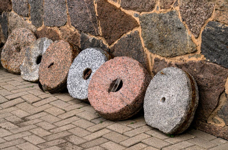 Old Stone Millstones Against the Wall. Village Life. Stock Photo ...