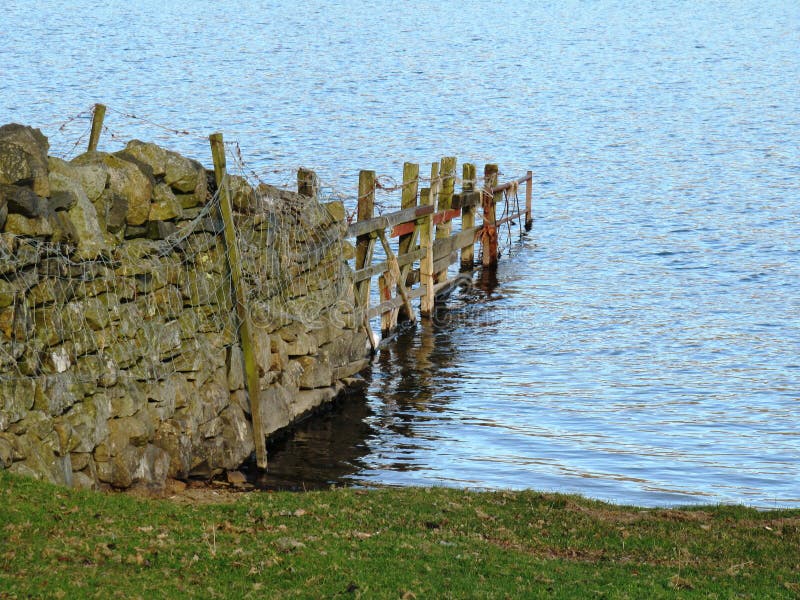 An Old Stone Wall Extending in To a Lake Stock Photo - Image of barrier ...