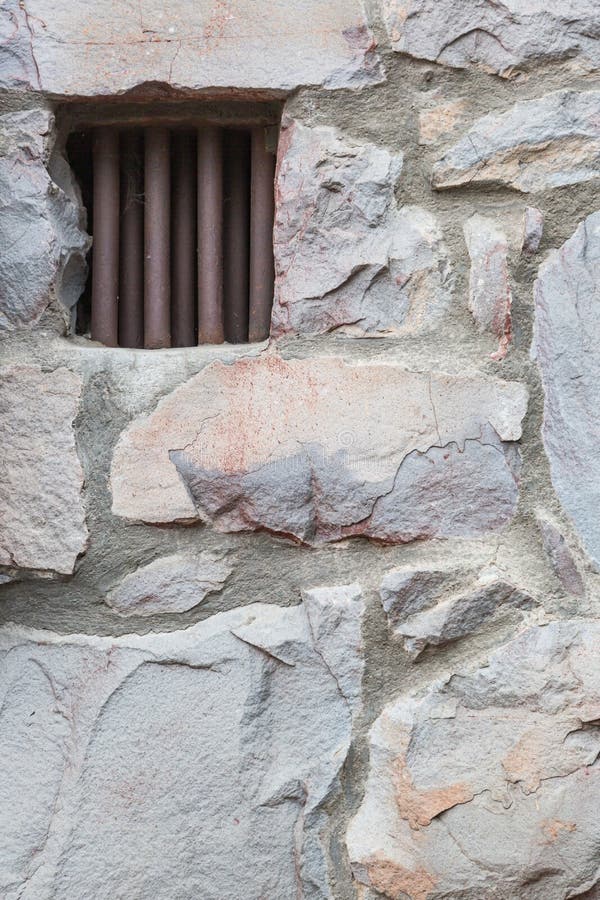 Old Stone Wall with Small Iron Barred Prison Cell Window Stock Image ...