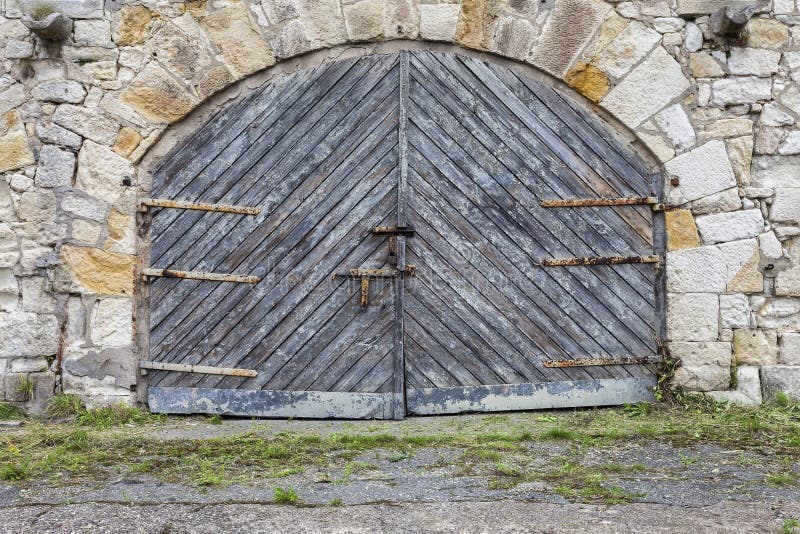 Old Stone Wall and Wooden Gates Stock Photo - Image of iron, background ...