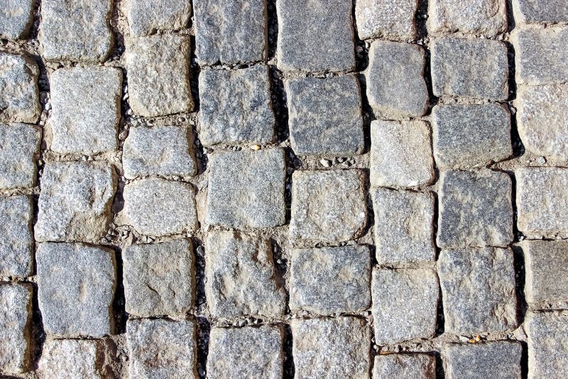 An Old Stoneblock Pavement Cobbled with Square Stone Blocks Stock Photo ...