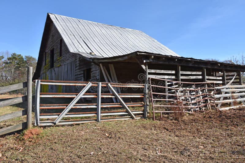 Old Barn With Fence Made From Old Steel Wheels Stock Image - Image of ...